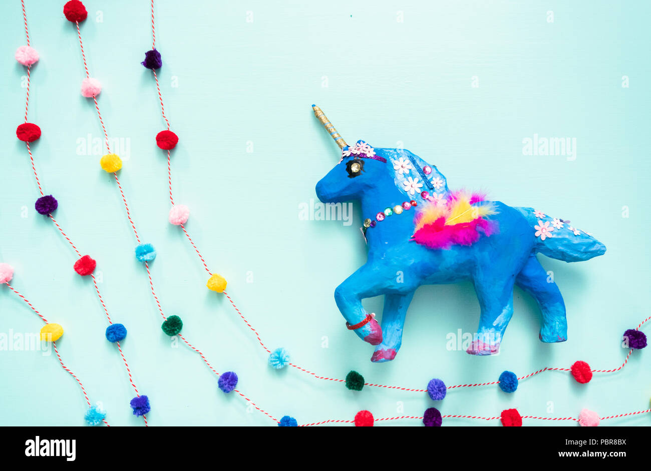 Kids craft. Painted blue and decorated with jewels and feathers paper ...