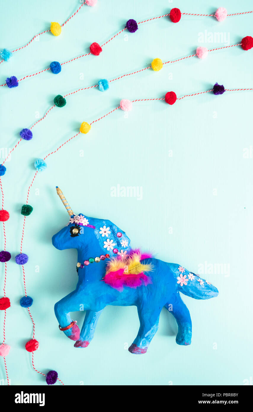 Kids craft. Painted blue and decorated with jewels and feathers paper ...