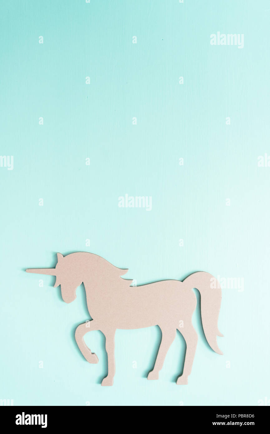 Unfinished unicorn cut out on blue background Stock Photo - Alamy