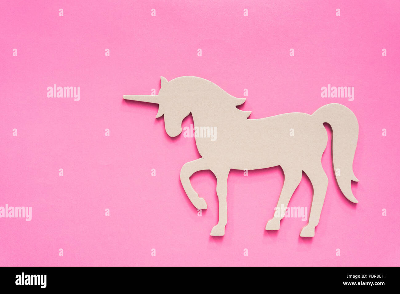 Unfinished unicorn cut out on pink background Stock Photo - Alamy
