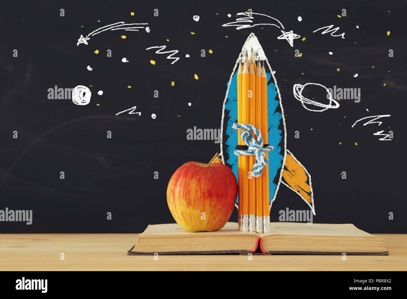 Open book rocket planet hi-res stock photography and images - Alamy