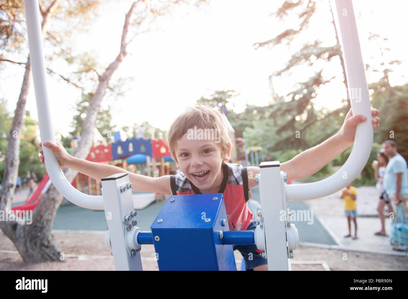 happy smiling kid sitting on exercise simulator training Stock Photo ...