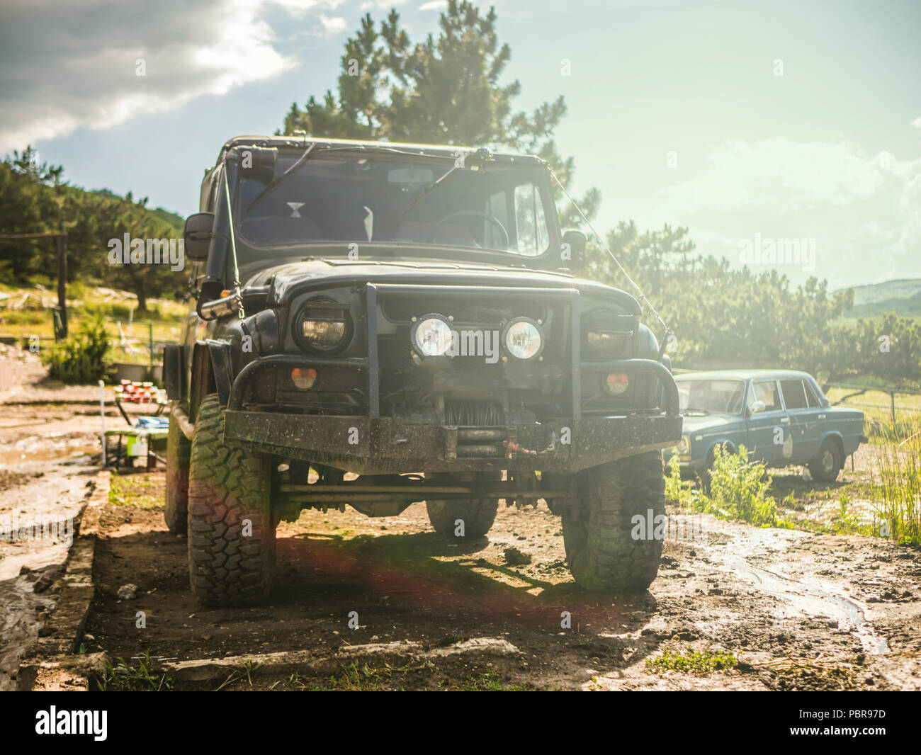 front view of massive 4x4 off-road car on the dirty ground panorama in ...