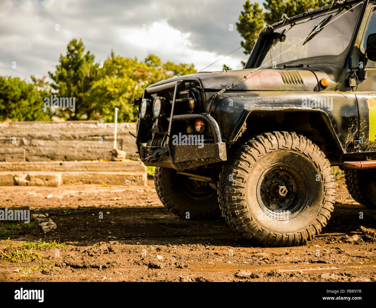 front view of massive 4x4 off-road car on the dirty ground panorama in ...