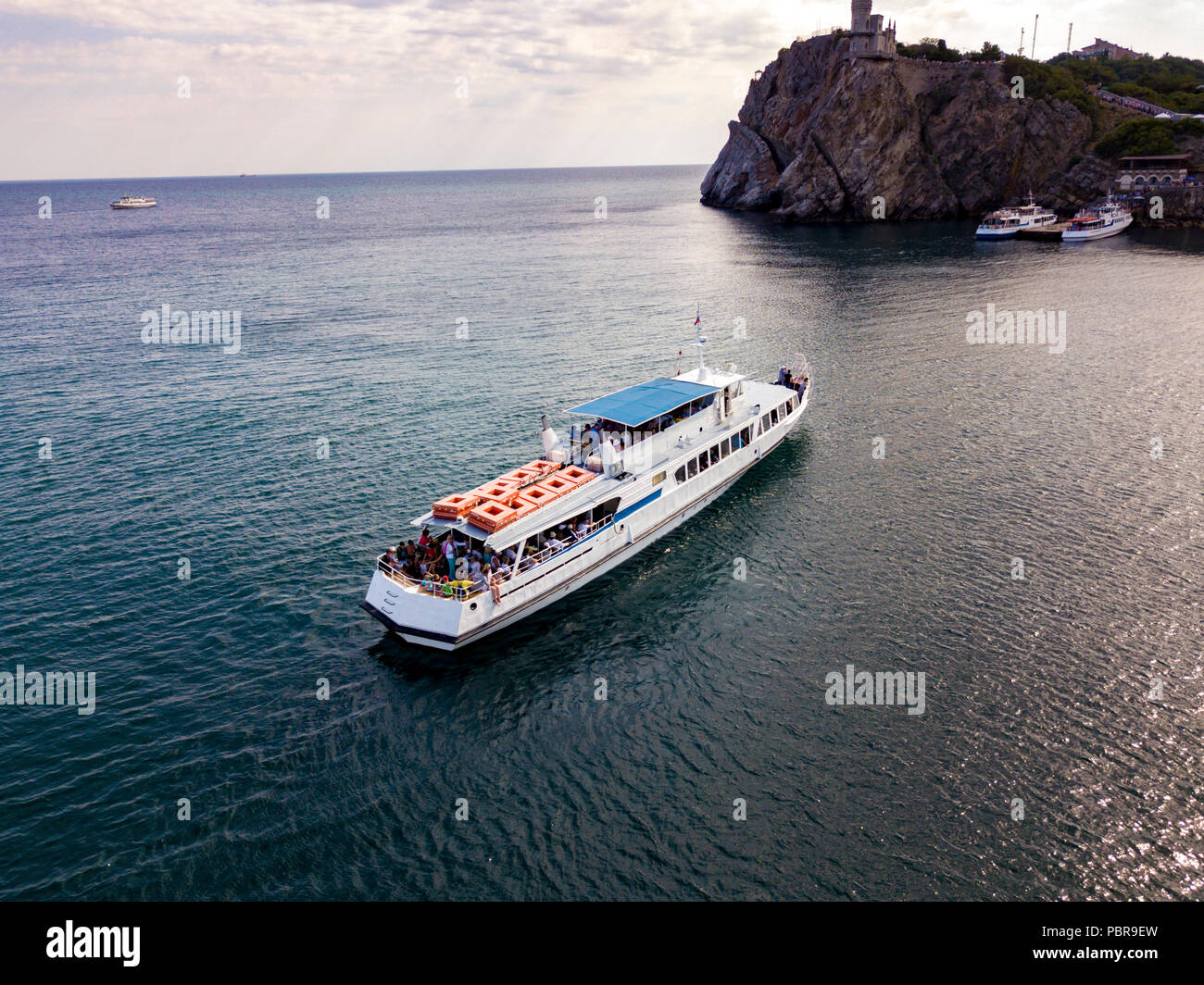 aerial cruise ferry ship come to the rock cliff mountain coast Stock ...