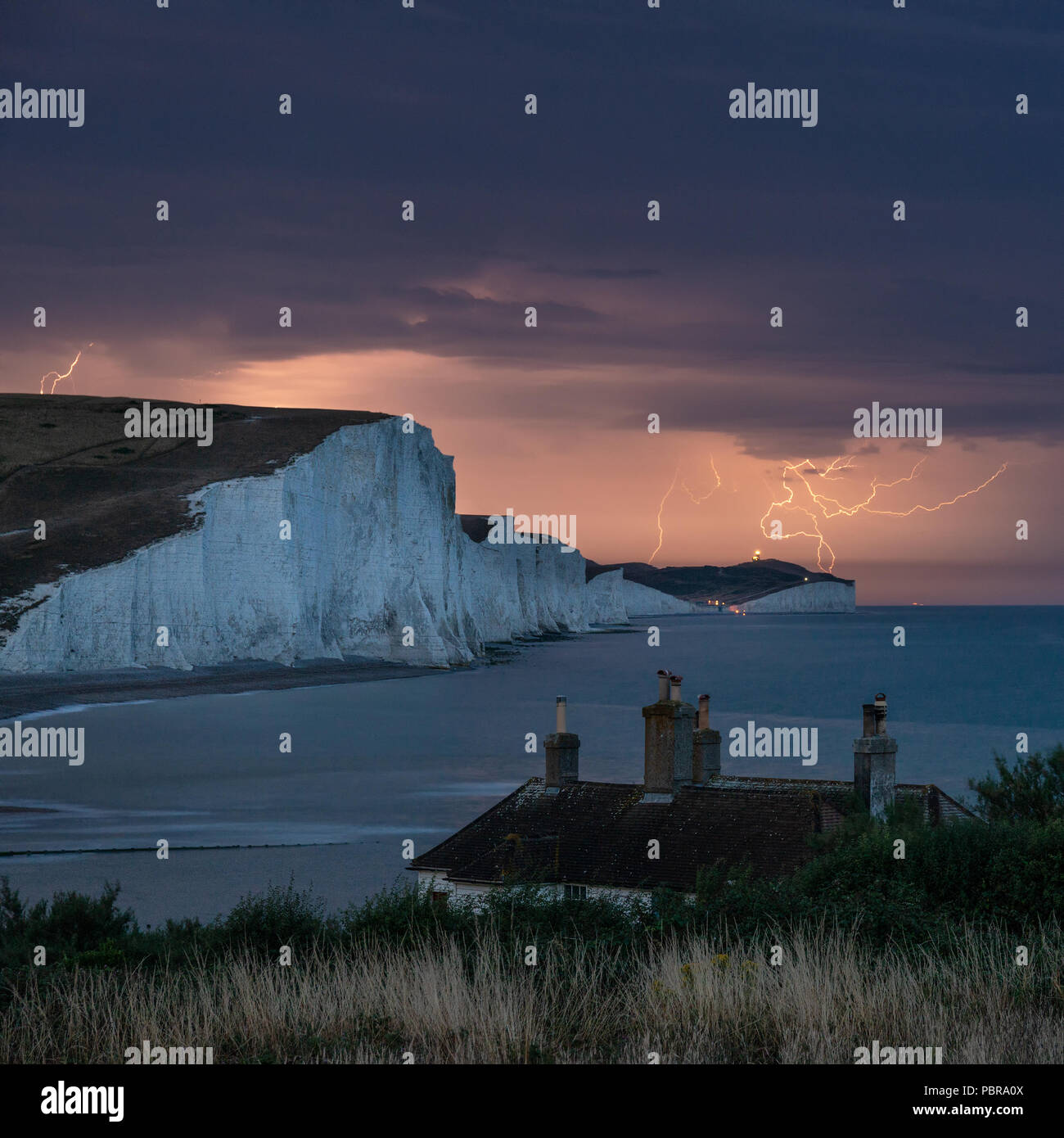 Amazing dramatic electrical lightning storm over white cliffs landscape ...