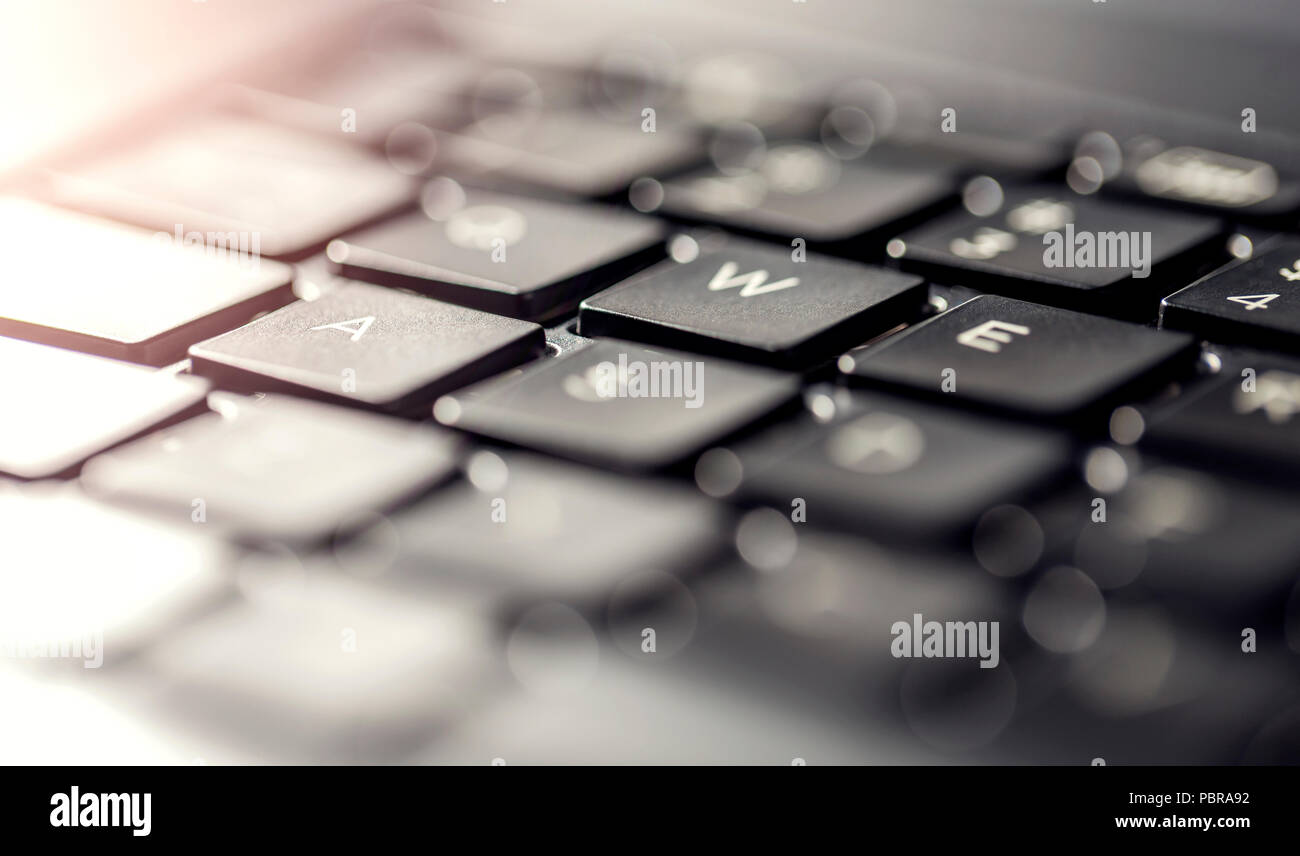 Macro view of black laptop keyboard buttons against back light Stock ...