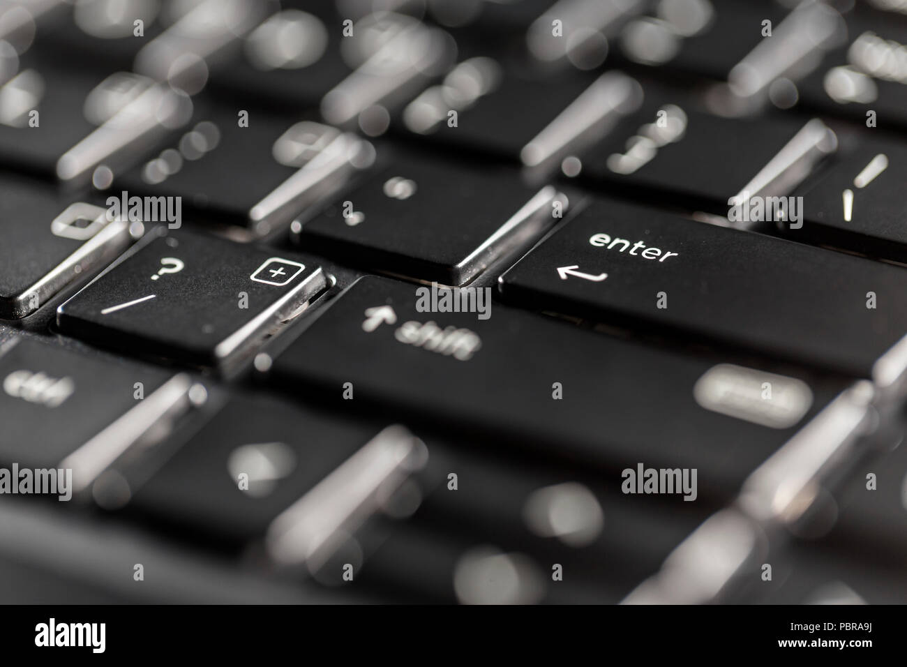 Macro view of black laptop keyboard buttons against back light Stock ...