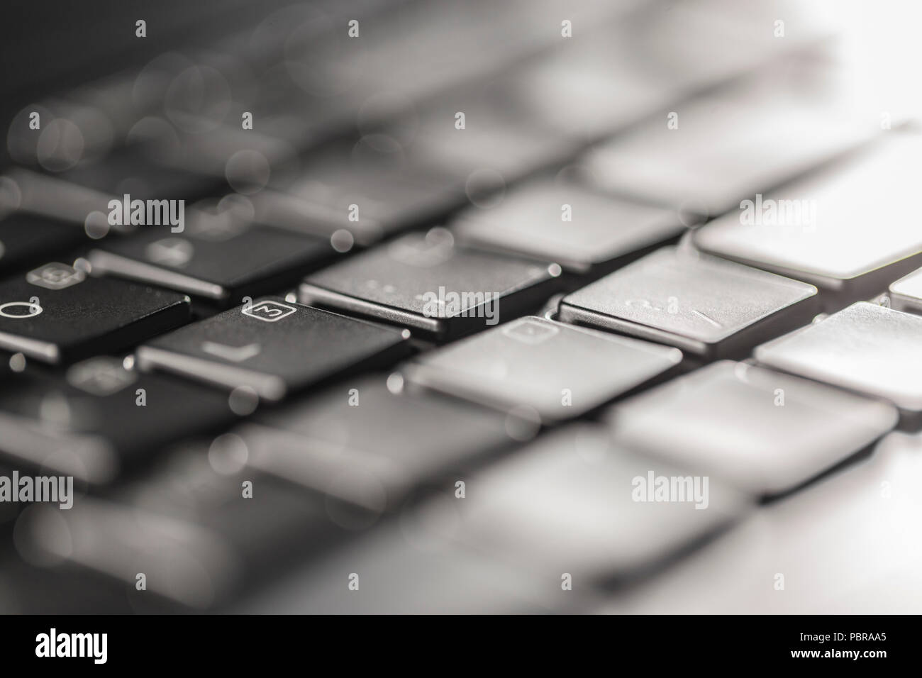 Macro view of black laptop keyboard buttons against back light Stock ...
