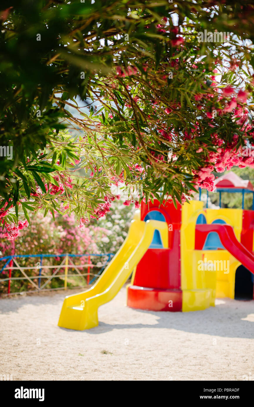 Children Playground in beautiful garden with mountains background Stock ...