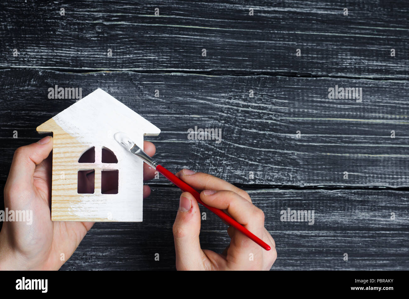 Hand paints a house. Concept of repair, hobby, work. Repair and ...