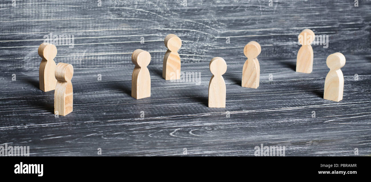 Crowd. Pedestrians and passers-by. Wooden figures of people stand apart ...