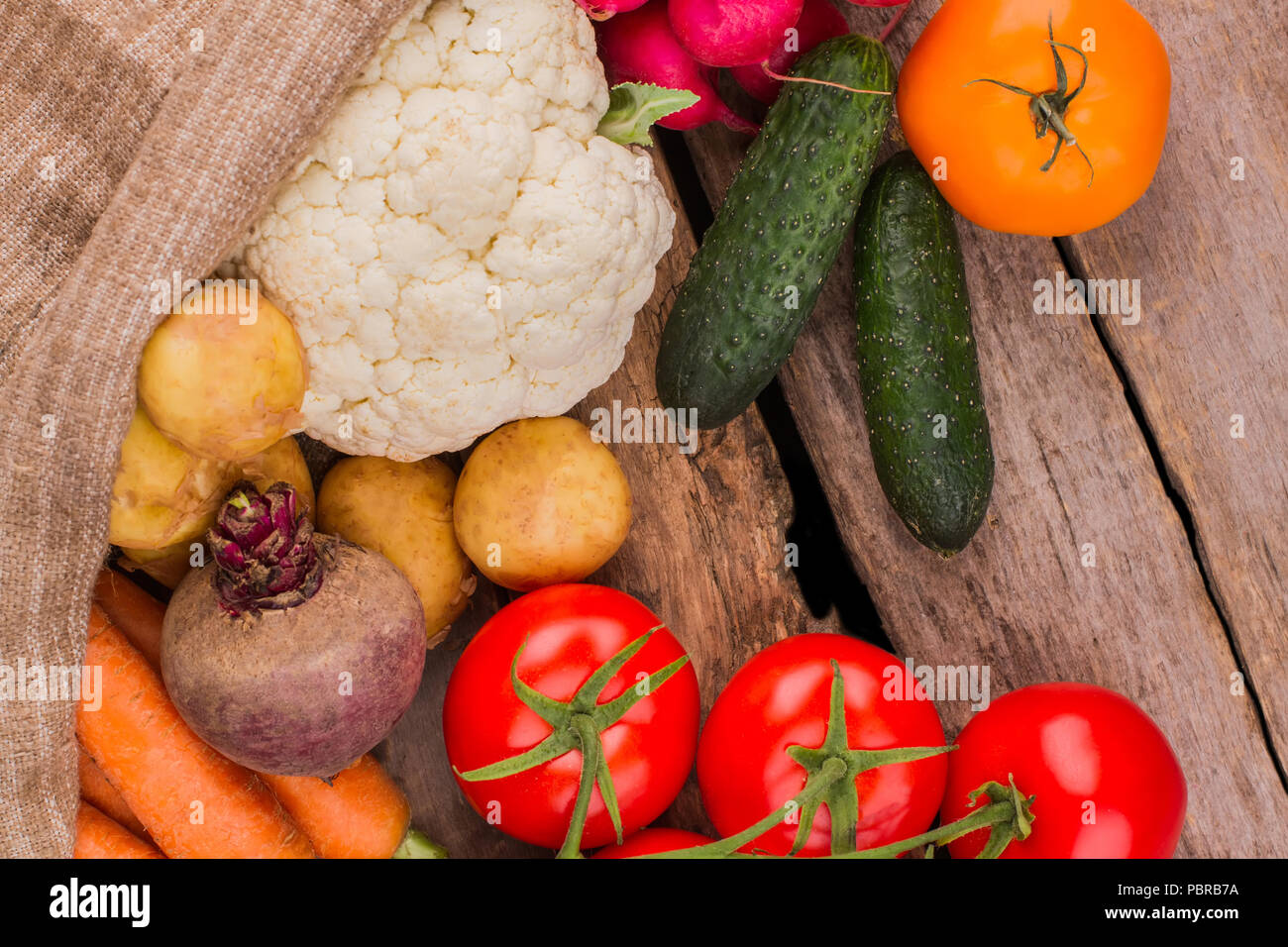 Heap of organic fresh vegeterian food. Close up. Wooden desk background ...