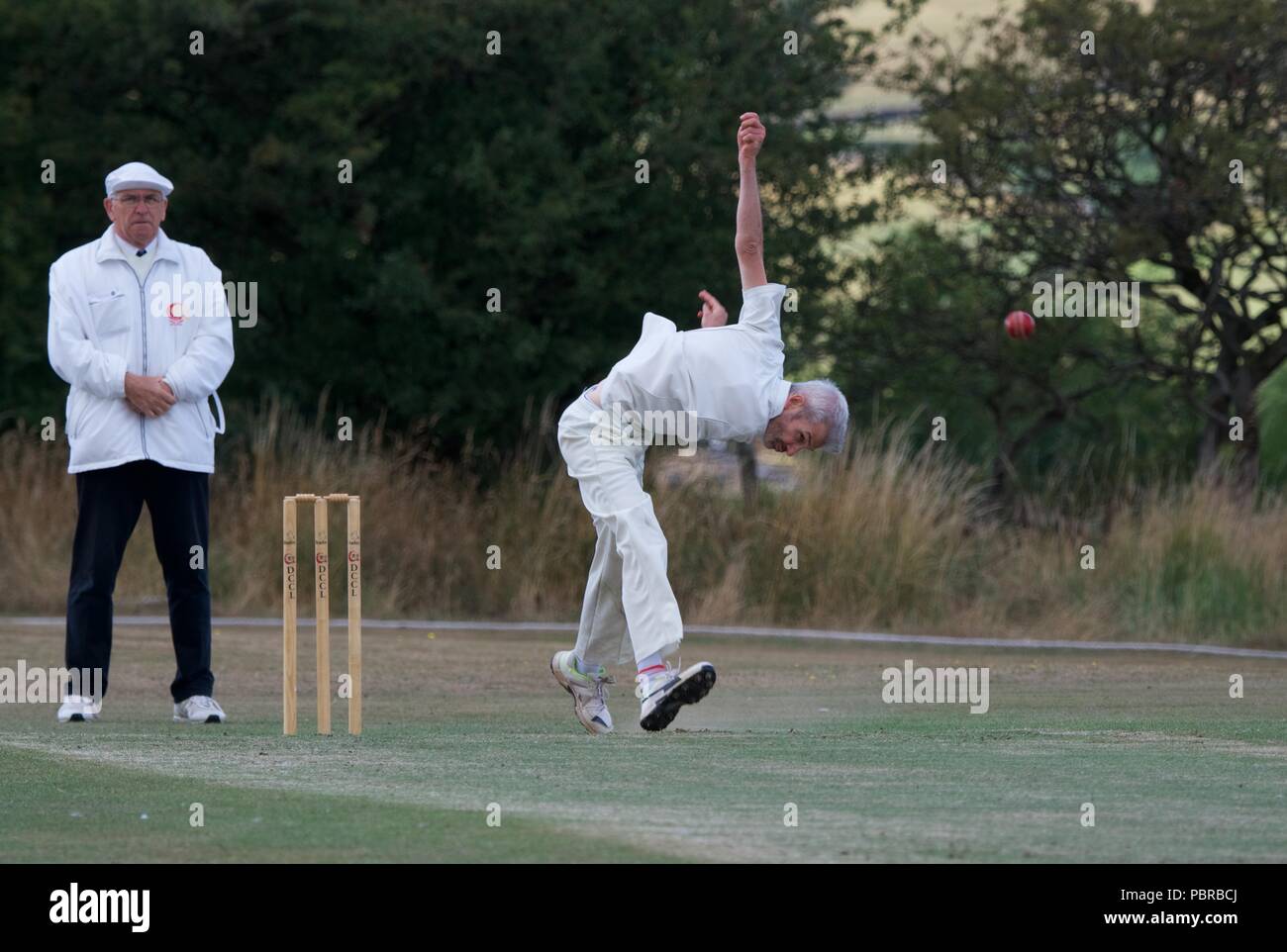 A fast bowler in action in a cricket match between Birch Vale and ...