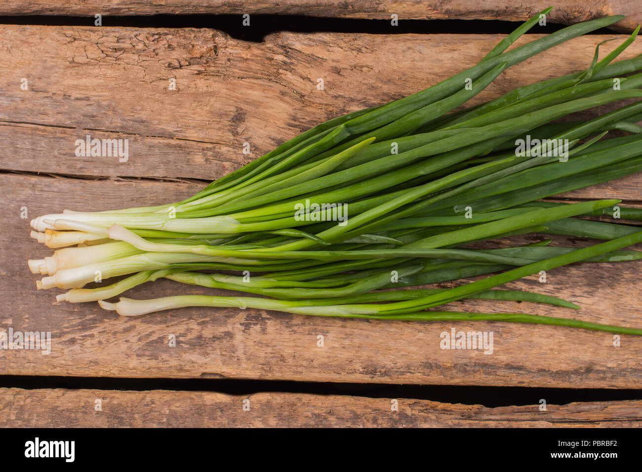 Bunch of green onion. Old rustic wooden table background Stock Photo ...