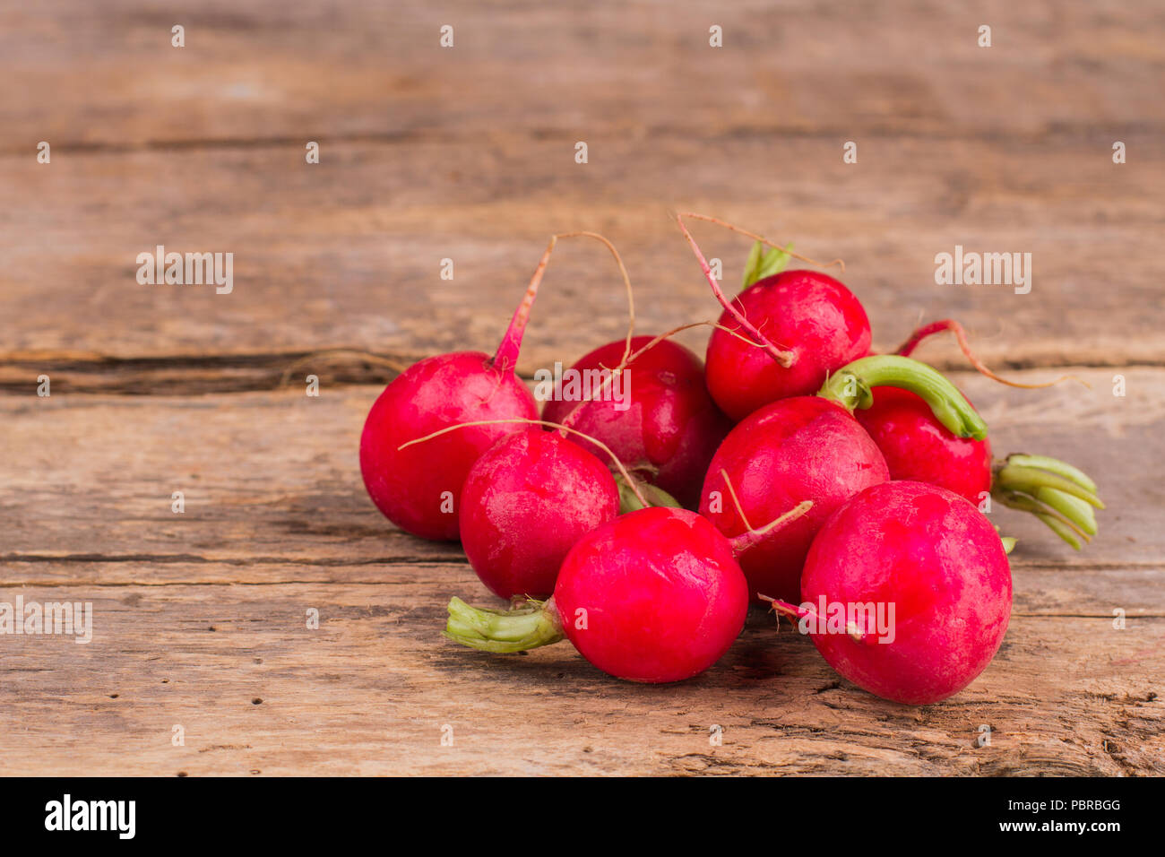 Bunch of radishes. Old vintage wooden desk table background Stock Photo ...