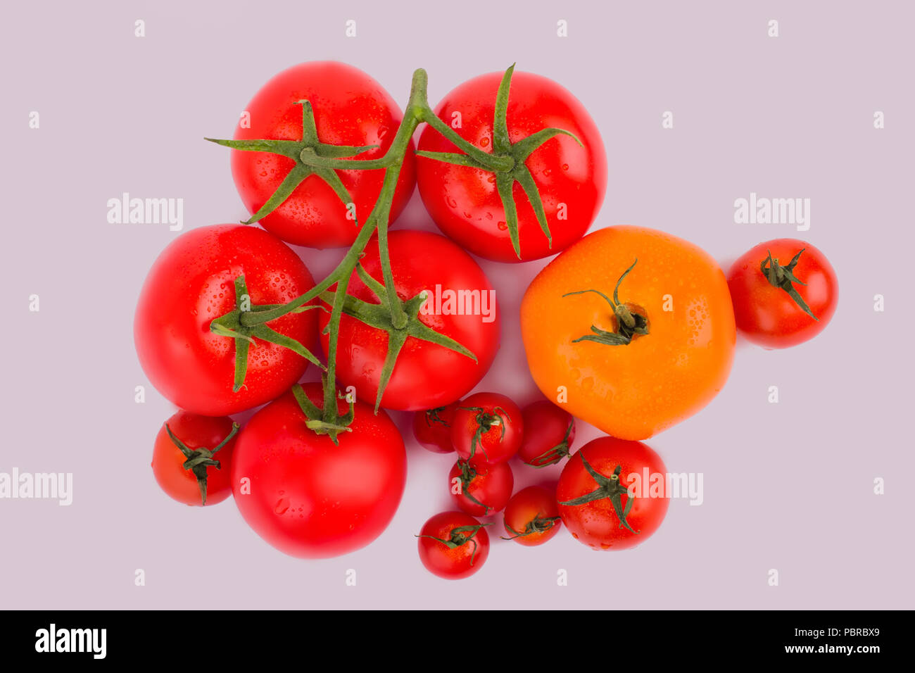 Washed clean tomatoes and cherry tomatoes. White isolated background ...