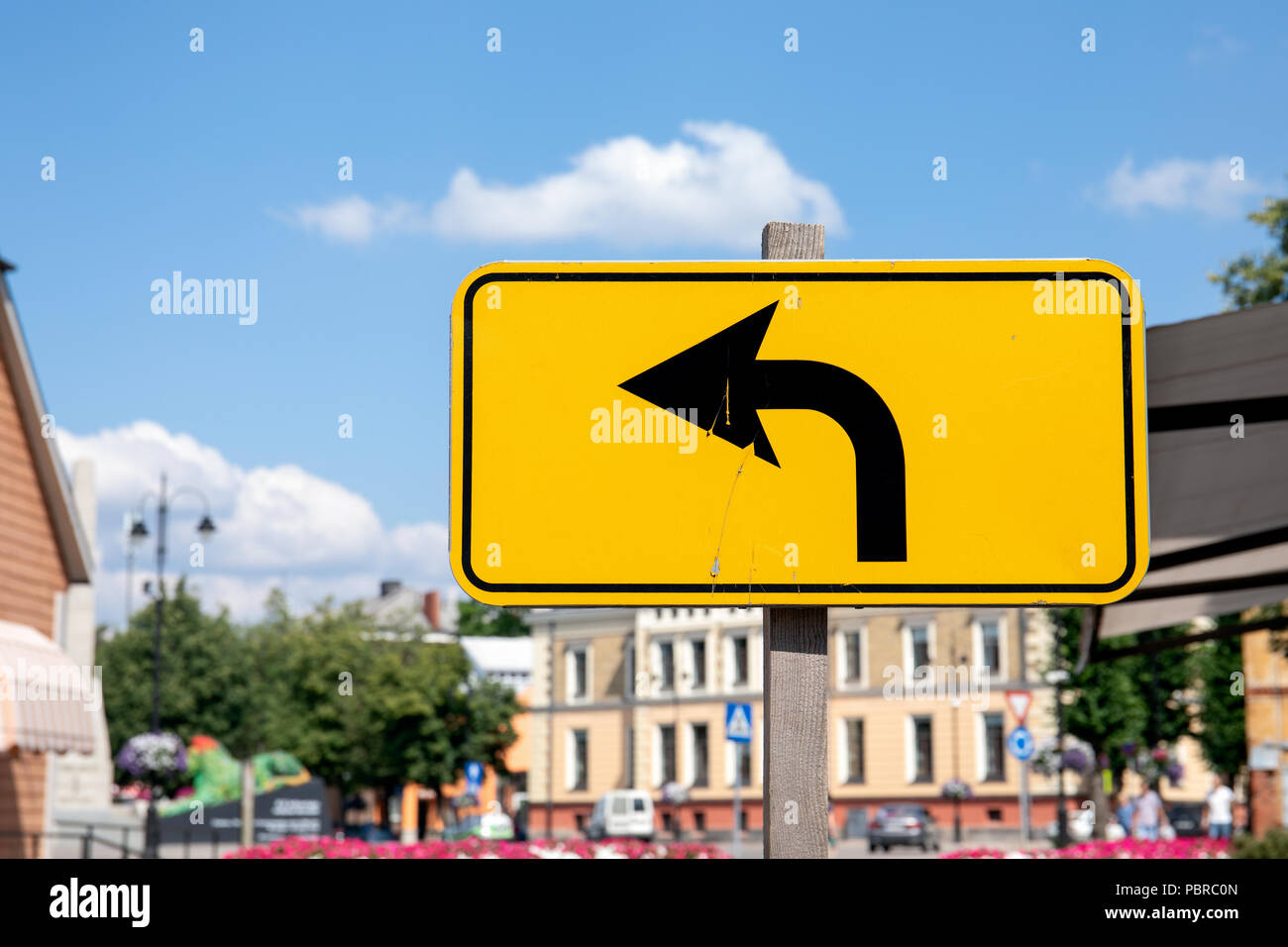 Yellow road sign for bypass with arrow Stock Photo - Alamy