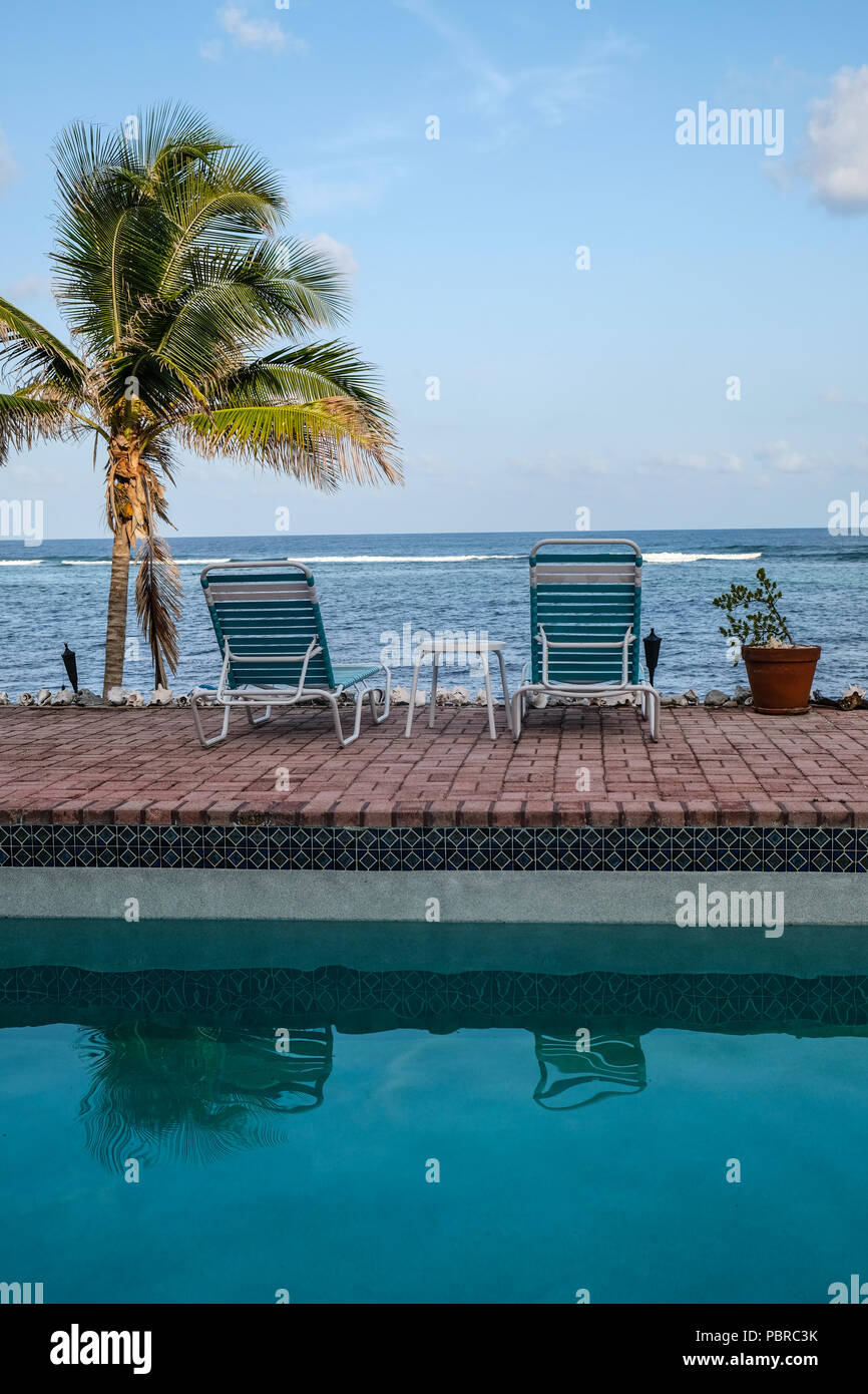 Resort swimming pool by beach at Cayman Island Stock Photo - Alamy