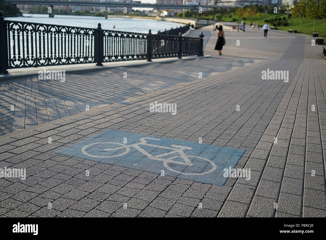 Bicycle lane mark on the street in sunset Stock Photo - Alamy