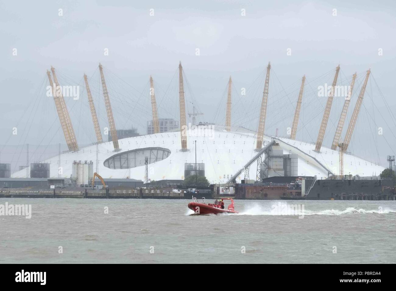 Speed boat on the River Thames with the O2 Arena in the background ...