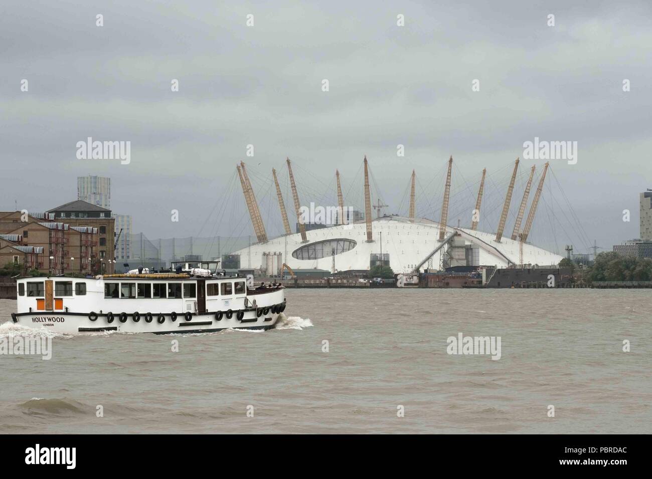 Speed boat on the River Thames with the O2 Arena in the background ...