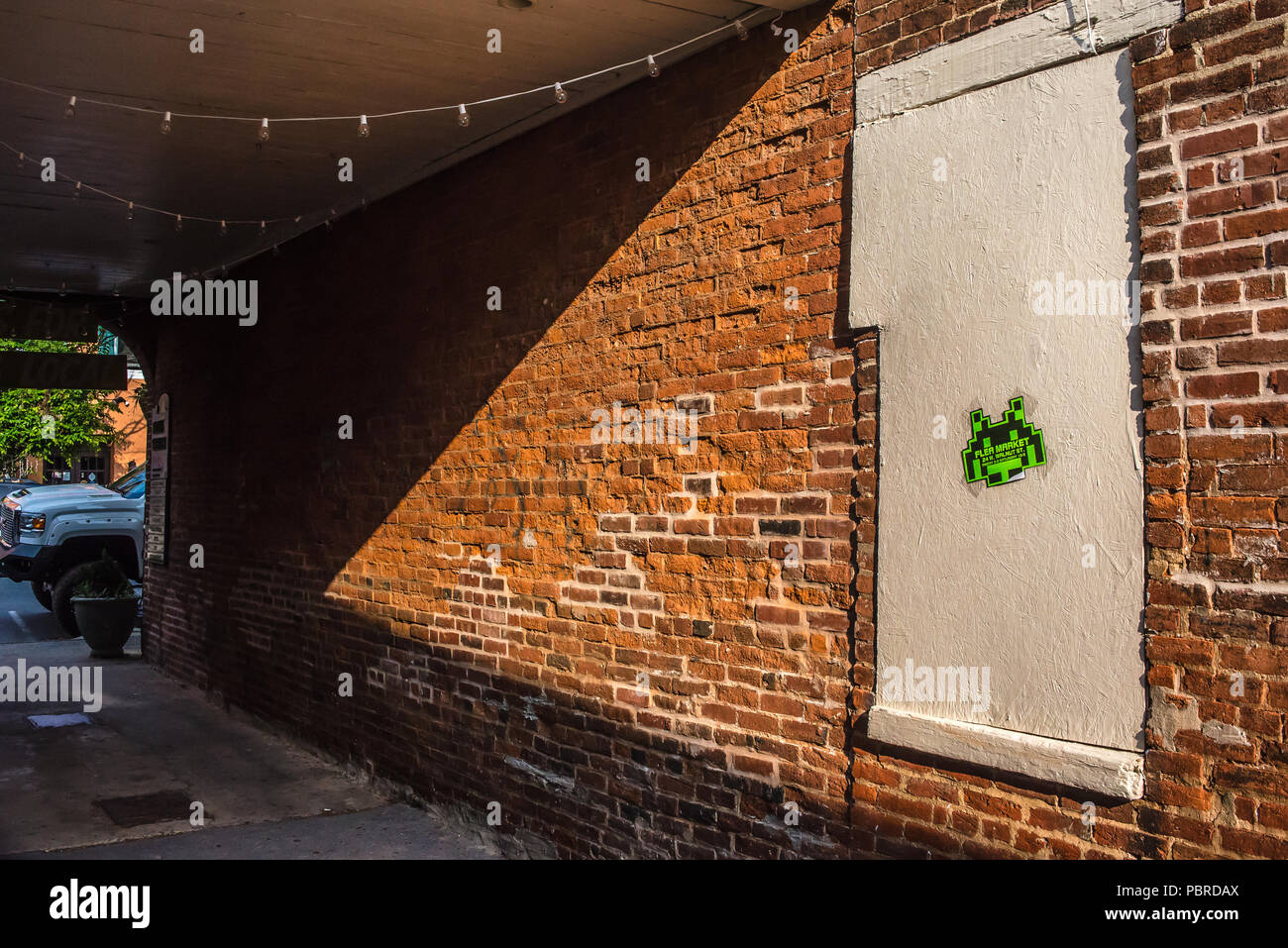 Back alley brick wall shadow patterns Stock Photo - Alamy