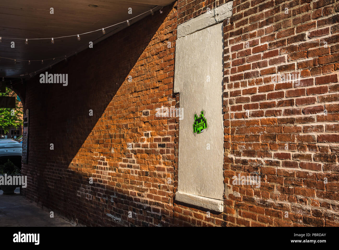 Back alley brick wall shadow patterns Stock Photo - Alamy