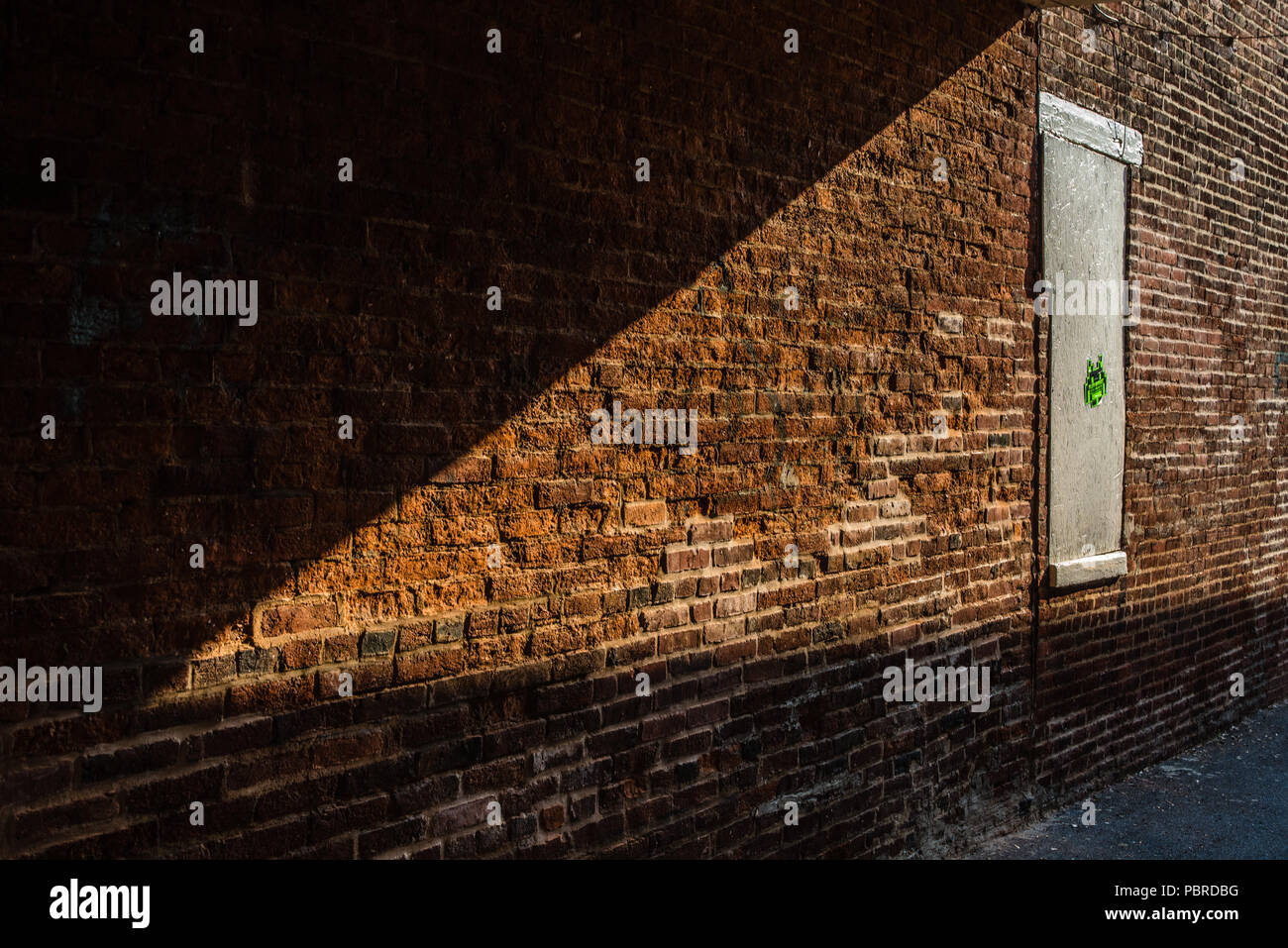 Back alley brick wall shadow patterns Stock Photo - Alamy