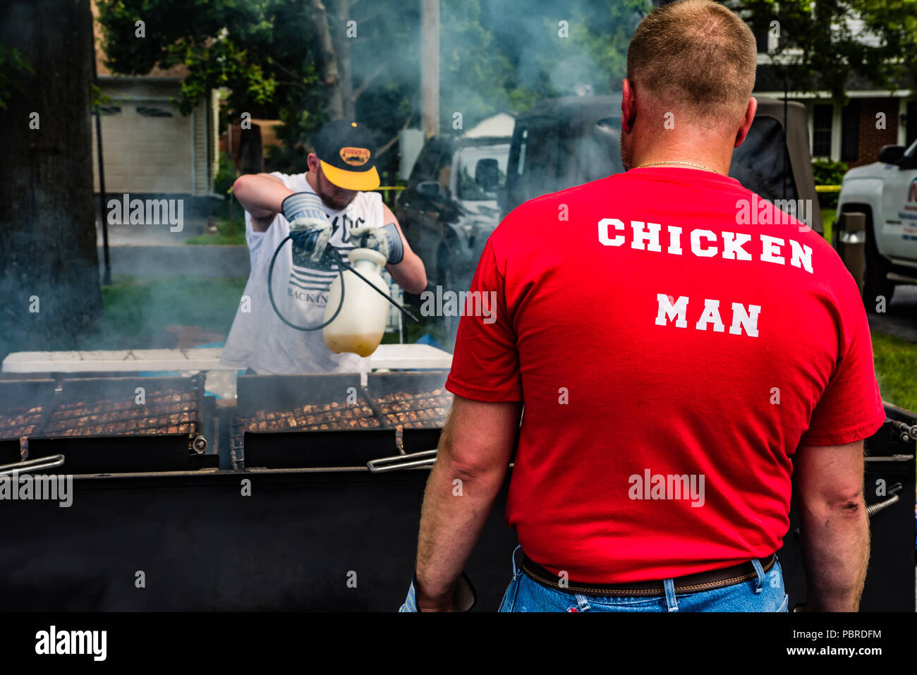 Church barbecue pit crew prepares chicken for strawberry festival Stock ...