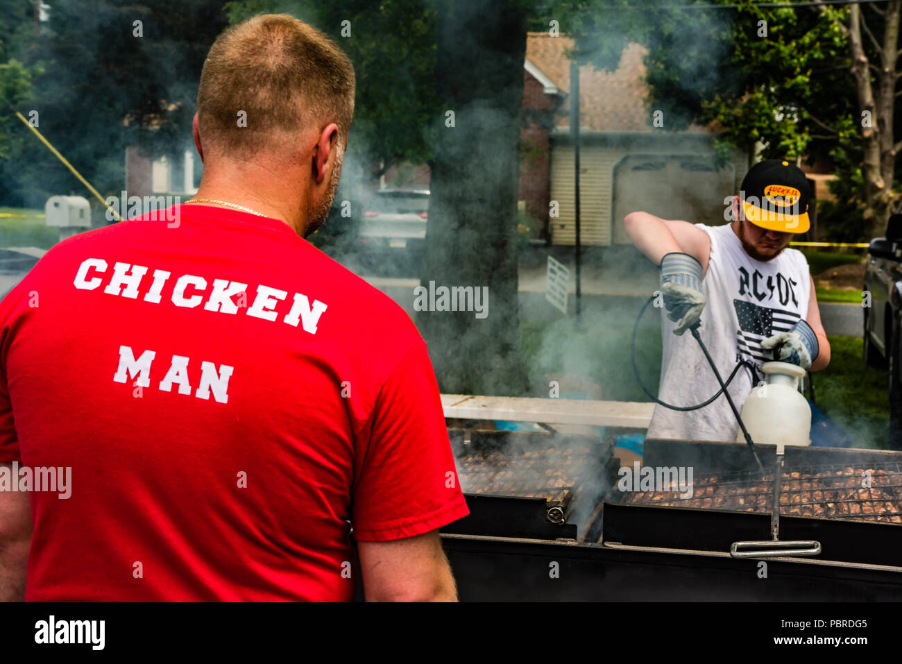 Church barbecue pit crew prepares chicken for strawberry festival Stock ...