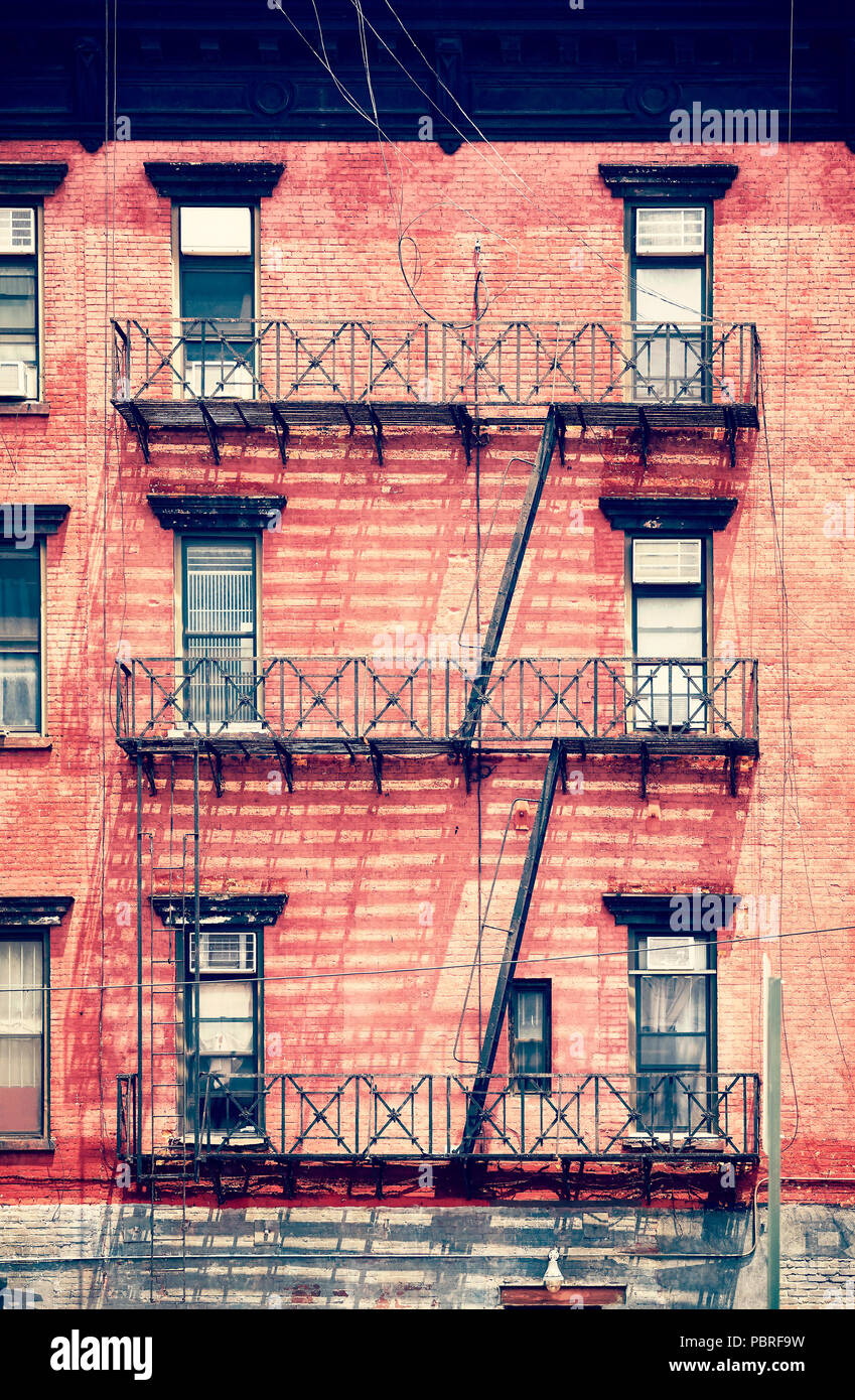 Old red brick building with fire escapes, one of the New York City ...