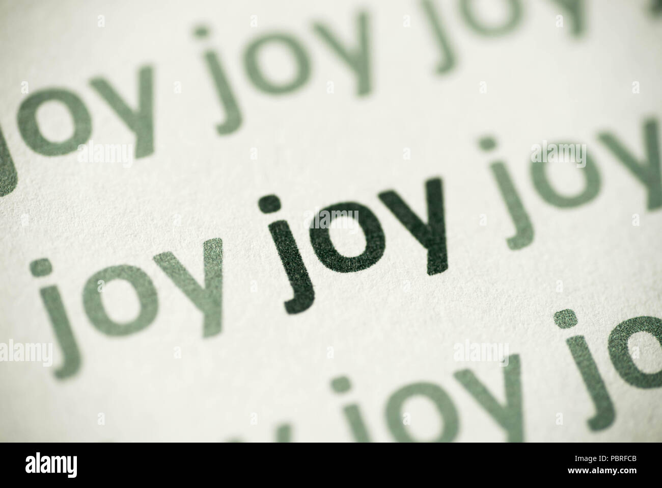 word joy printed on white paper macro Stock Photo - Alamy