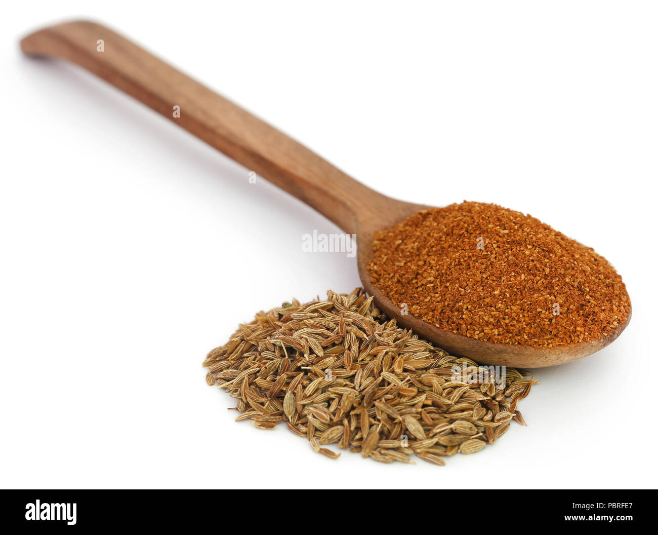 Crushed cumin with whole ones over white background Stock Photo - Alamy