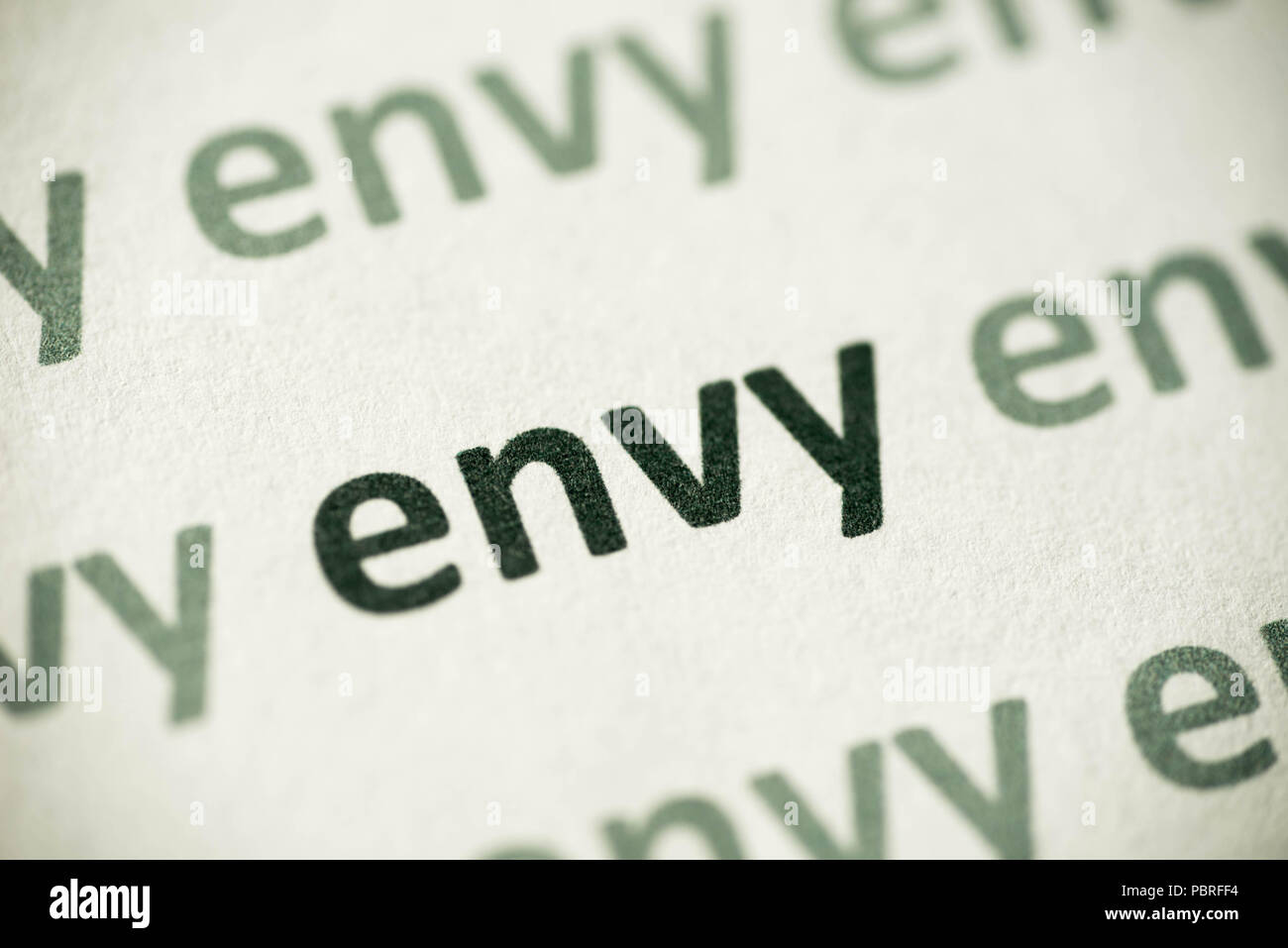 word envy printed on white paper macro Stock Photo - Alamy