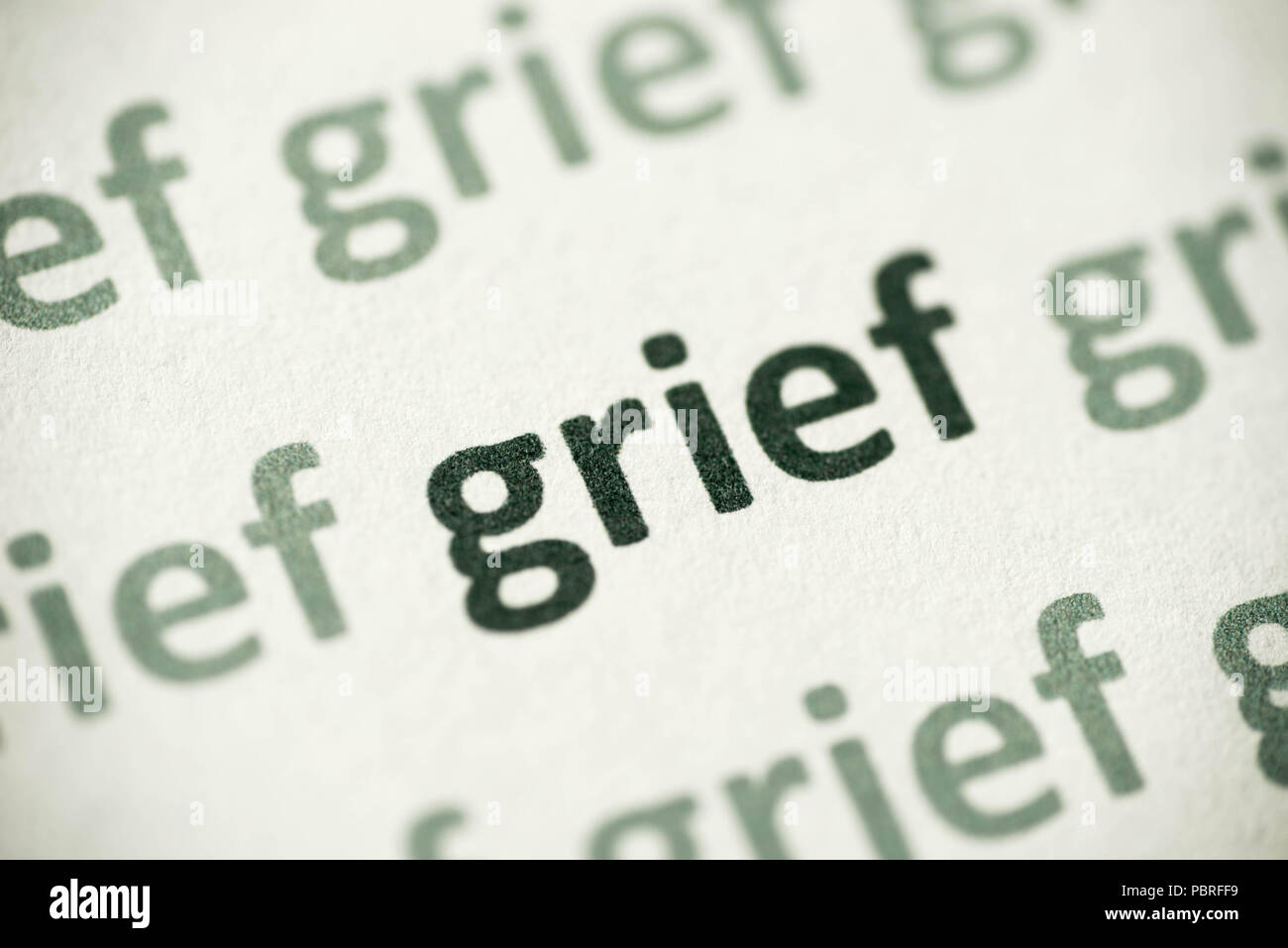 word grief printed on white paper macro Stock Photo - Alamy