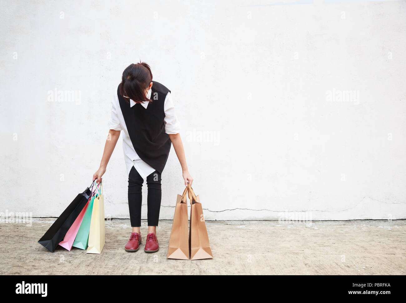 Female Lady carrying Colorful Shopping Bags Concept. Wrong posture ...