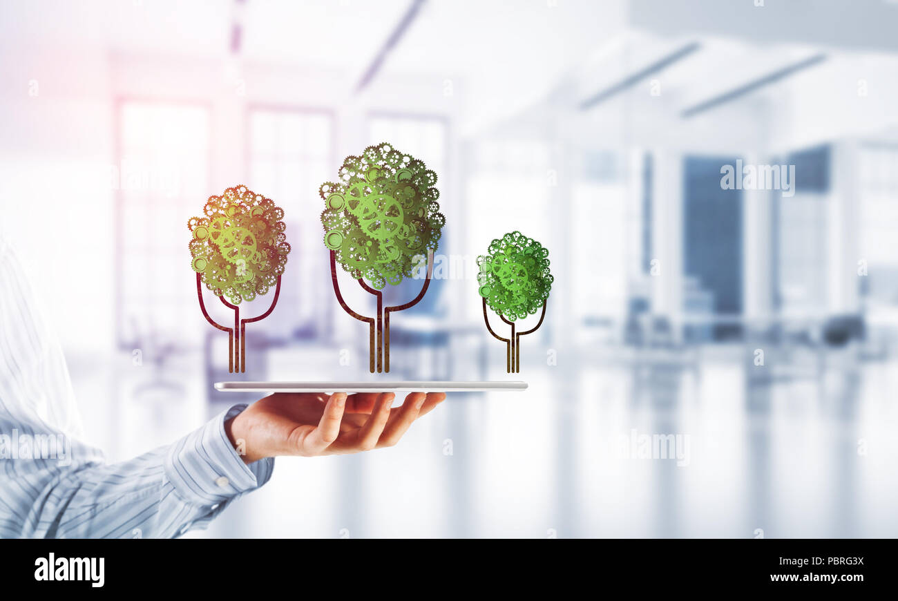 Eco green environment concept presented by tree as working mechanism or ...