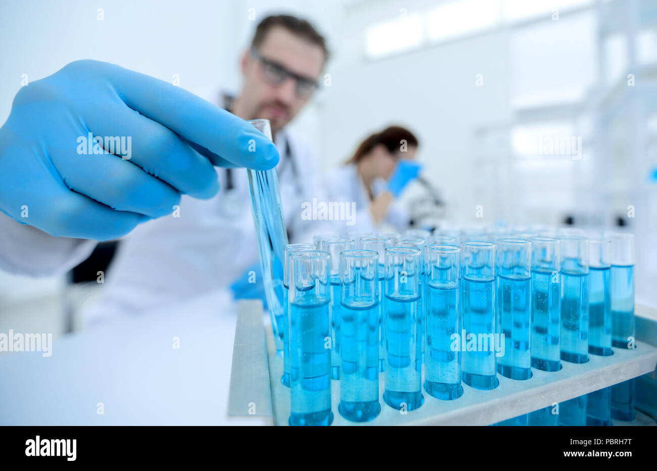 serious scientist working with liquids Stock Photo - Alamy