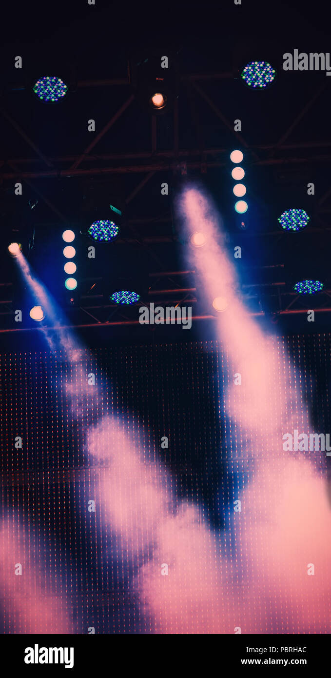 Lighting the stage during a musical rock concert and artificial fog ...