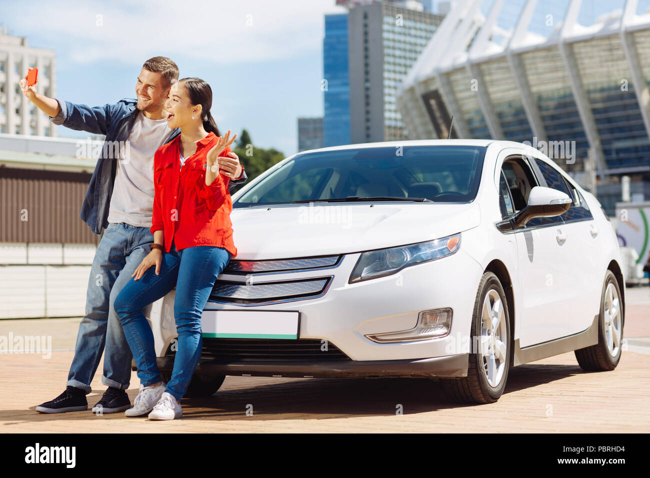Happy couple standing near car hi-res stock photography and images - Alamy