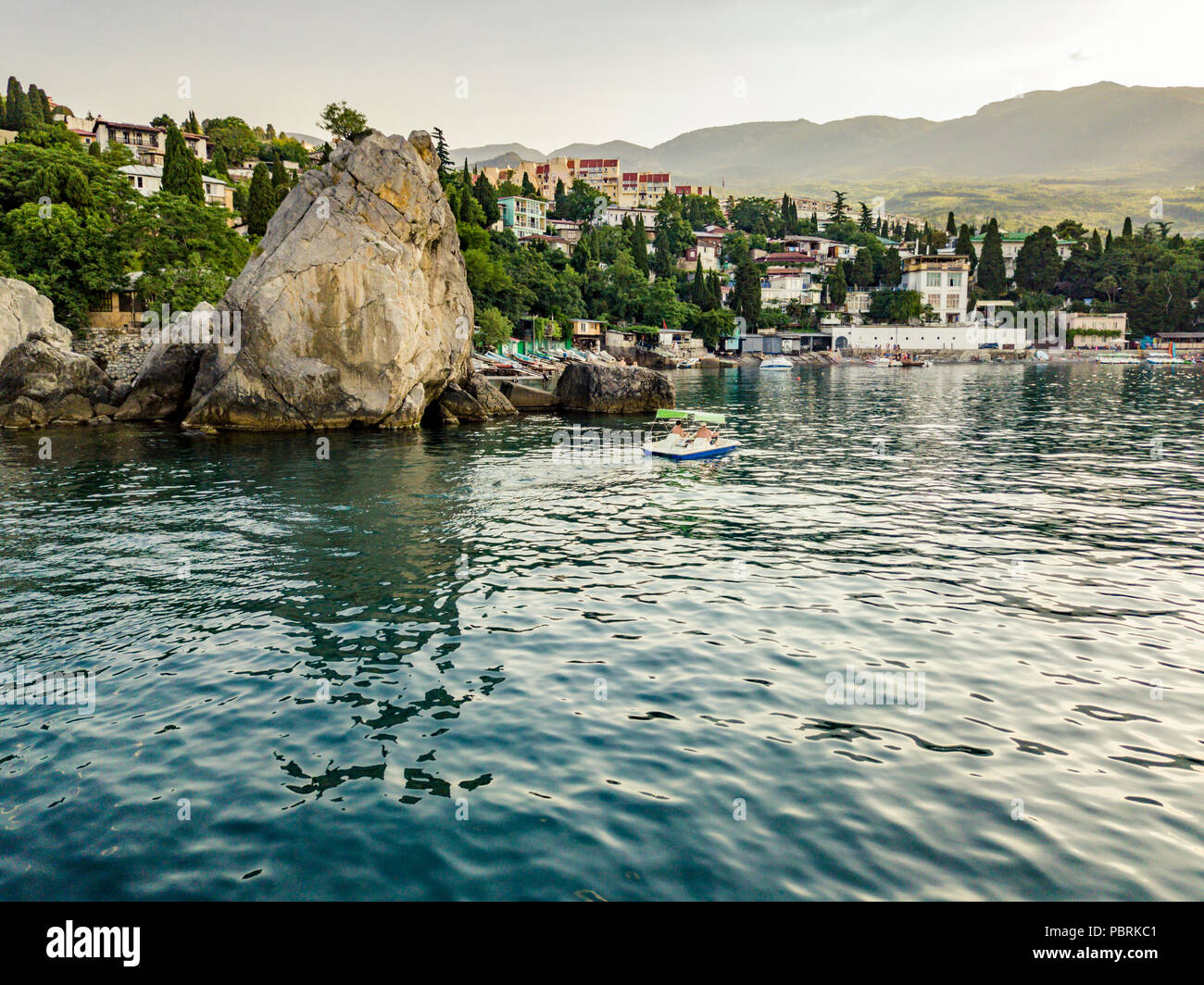 aerial tourist in small catamaran near the rock sea coast in europe ...
