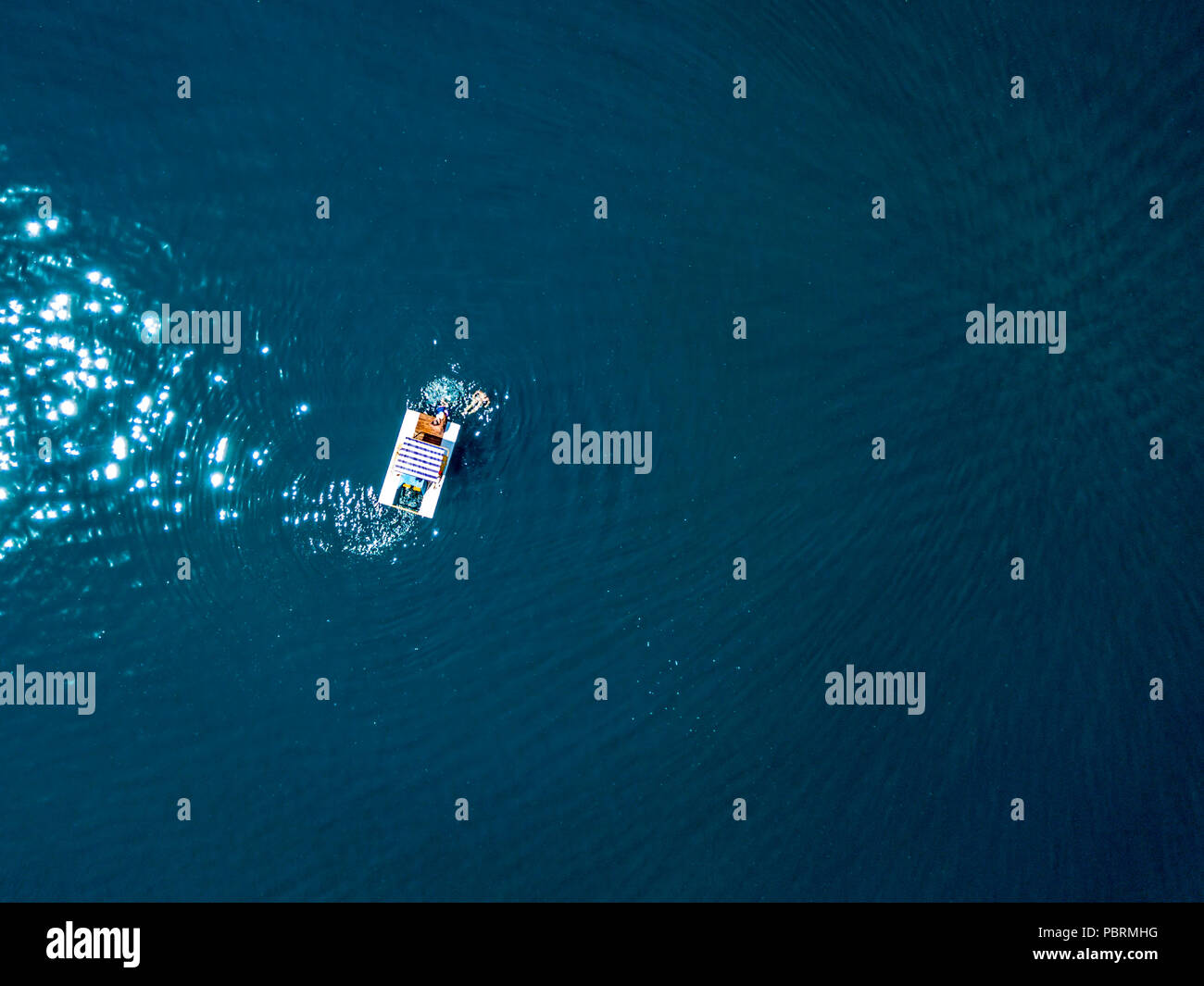 aerial top down view of small catamaran isolated on the water surface ...