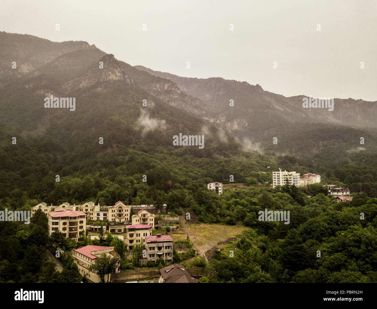 summer holidays resort hotel buildings in the mountains on a stormy ...
