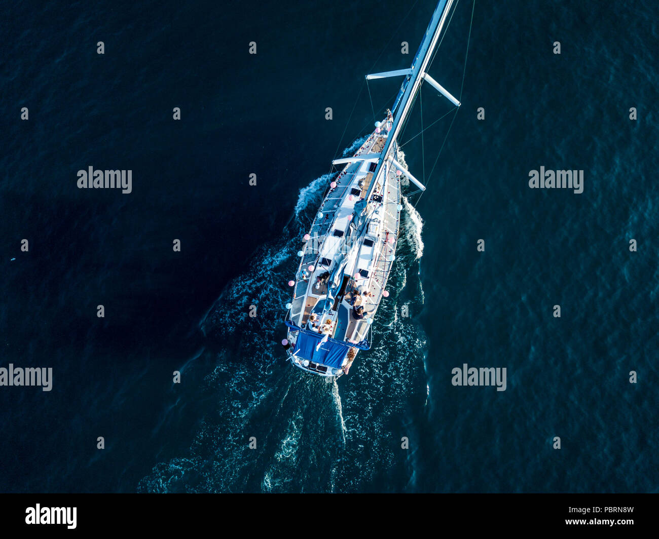 overhead top aerial view of luxury sail boat in the crystal clear blue ...