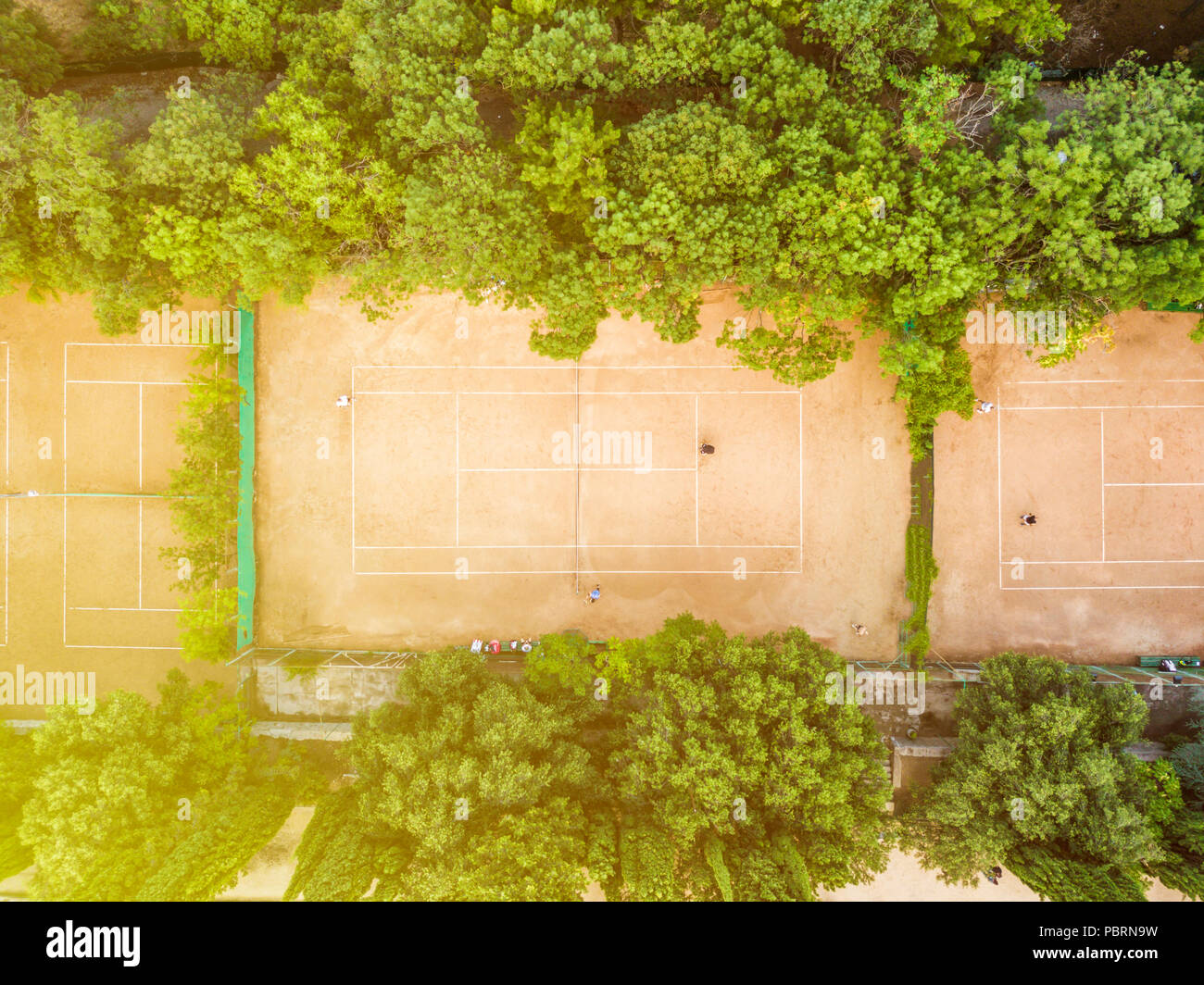 aerial sunny summer tennis courts top view from above near the sea in ...