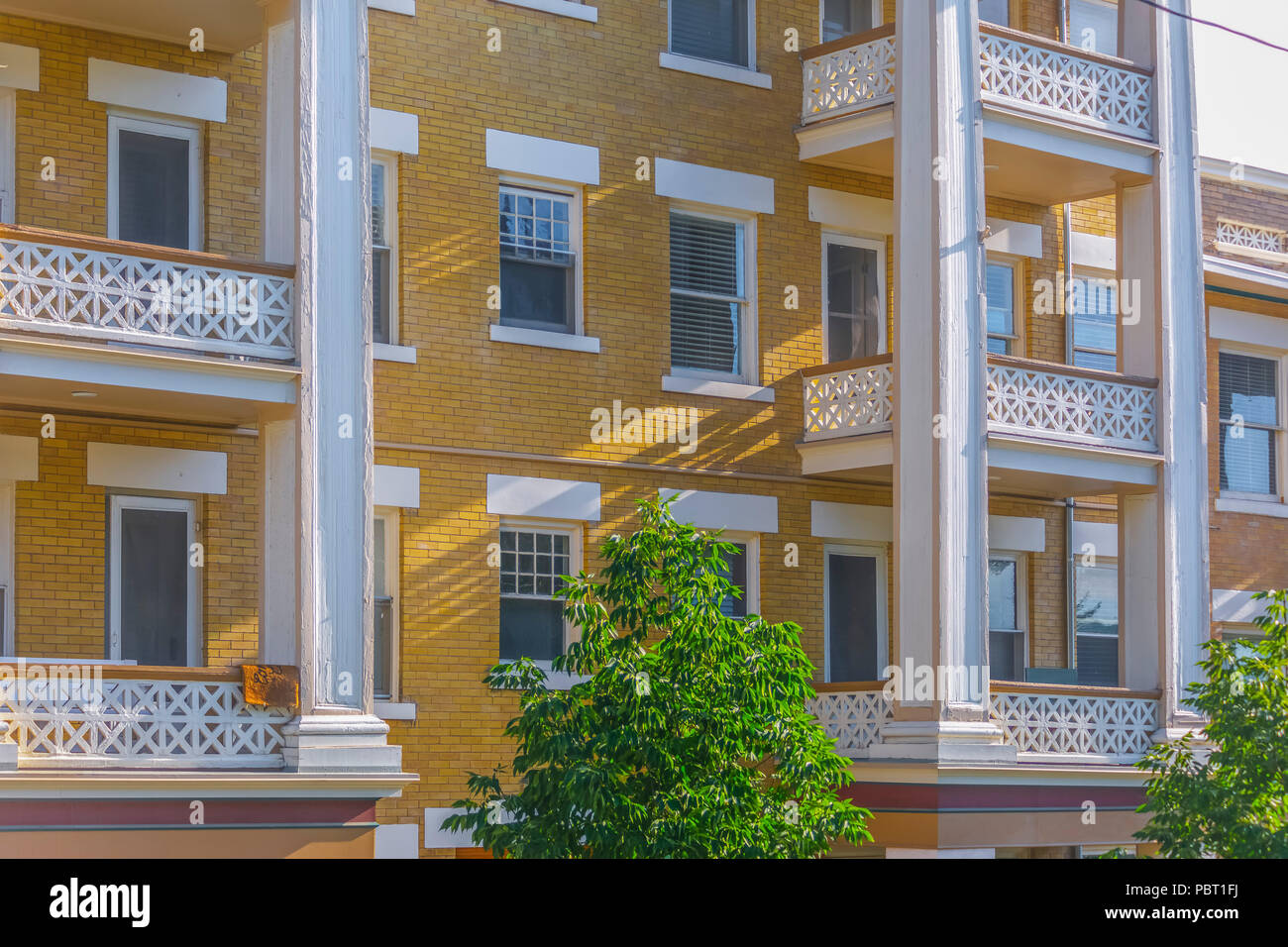 Front face of yellow building and white pillars Stock Photo - Alamy