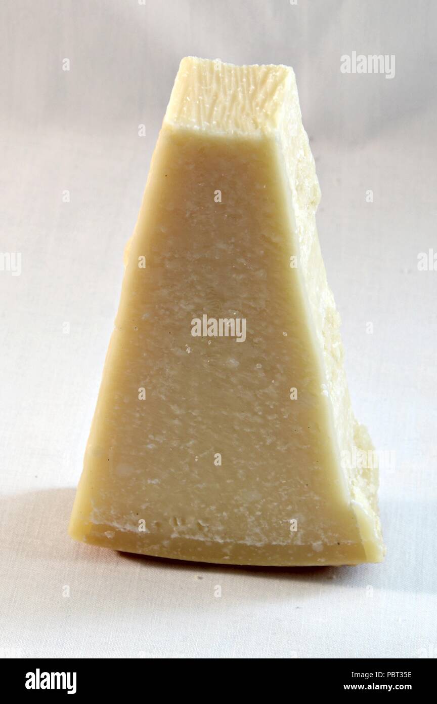 piece of grana padano cheese on white background Stock Photo - Alamy