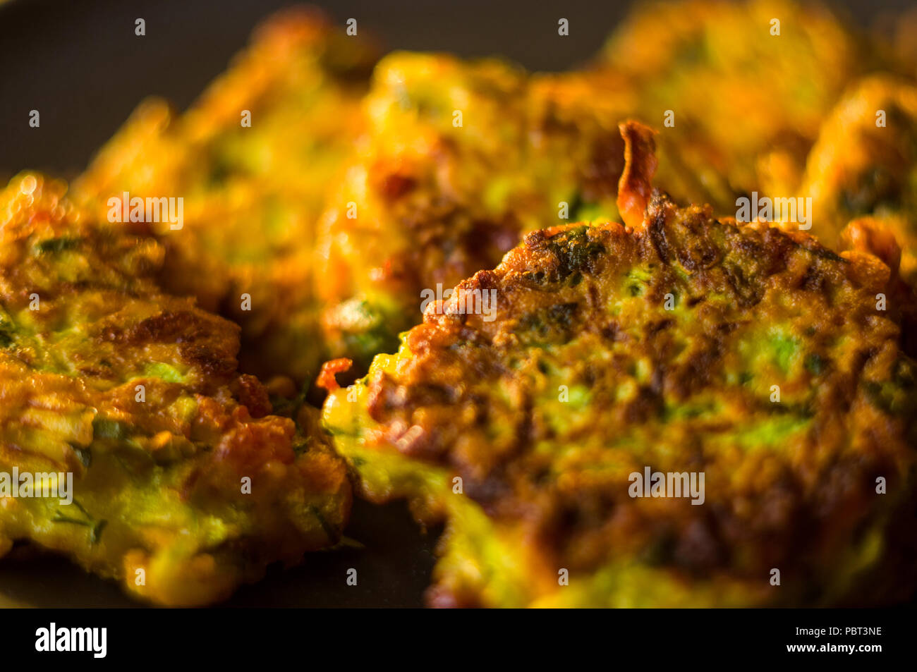 Fried vegetable fritters with zucchini, carrots, herbs, eggs, and ...