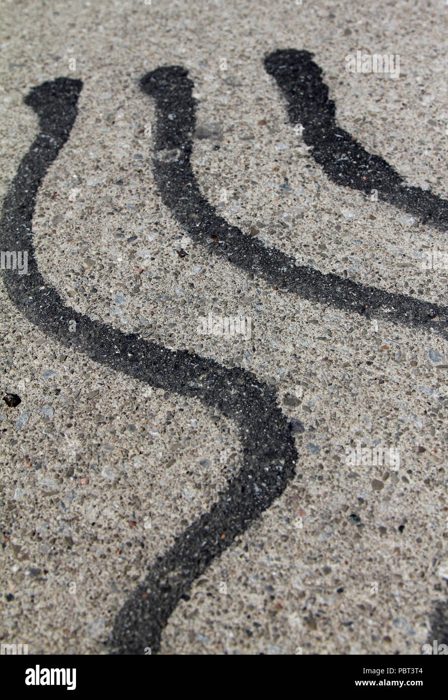 Three black streaks on pavement Stock Photo - Alamy